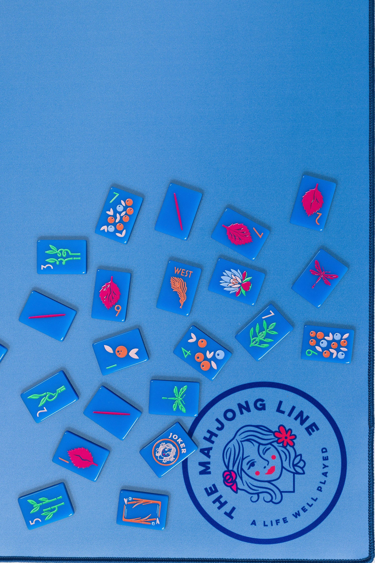 Light blue game mat paired with mahjong tiles– The Mahjong Line