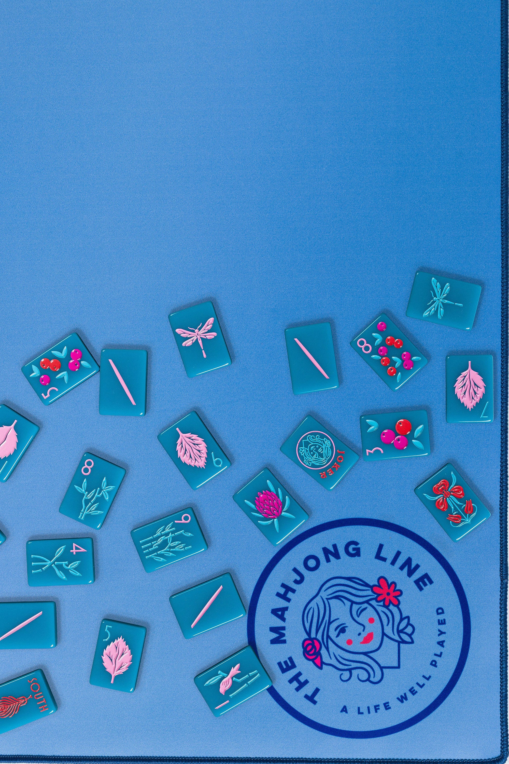 Light blue game mat paired with mahjong tiles– The Mahjong Line