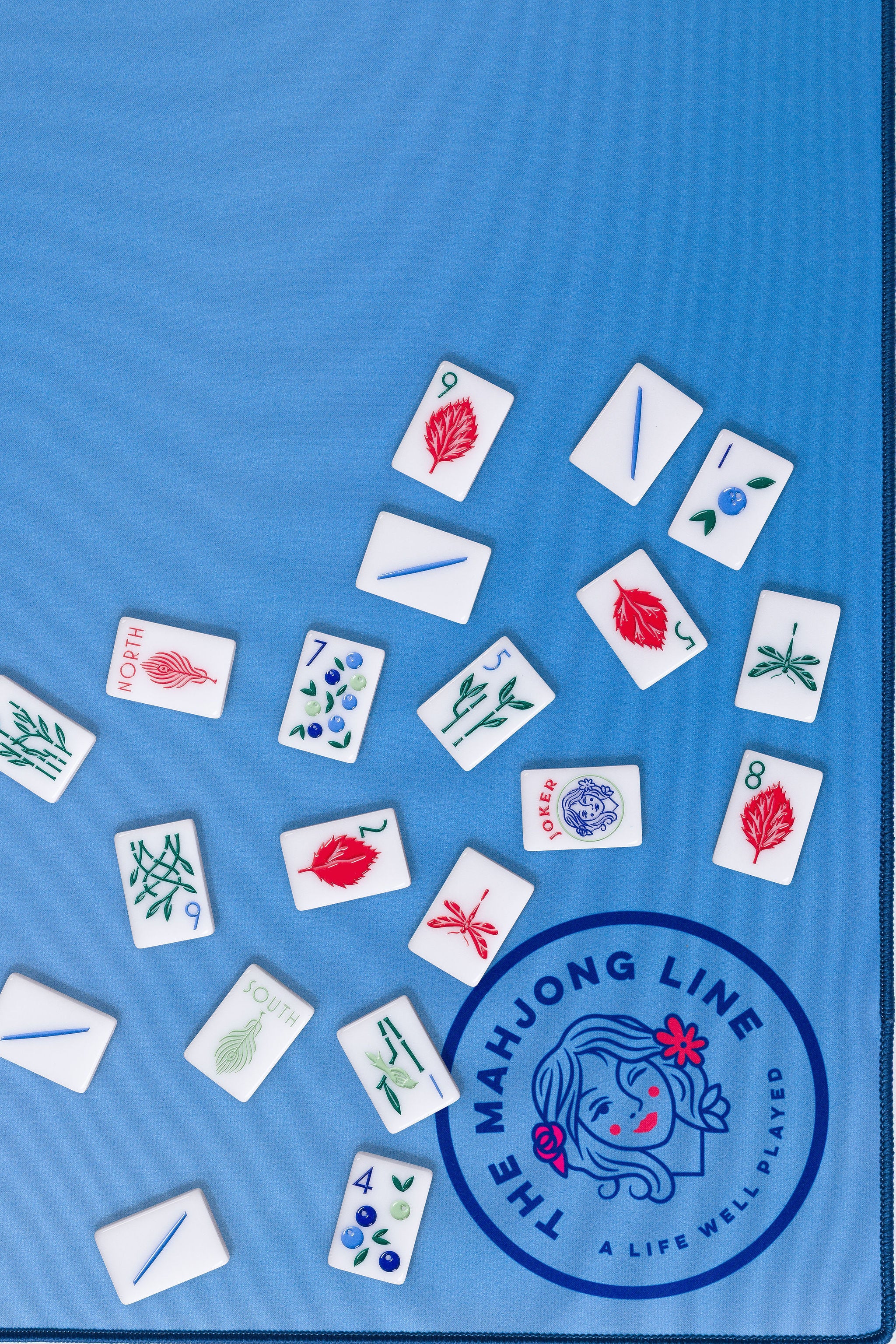 Light blue game mat paired with mahjong tiles– The Mahjong Line