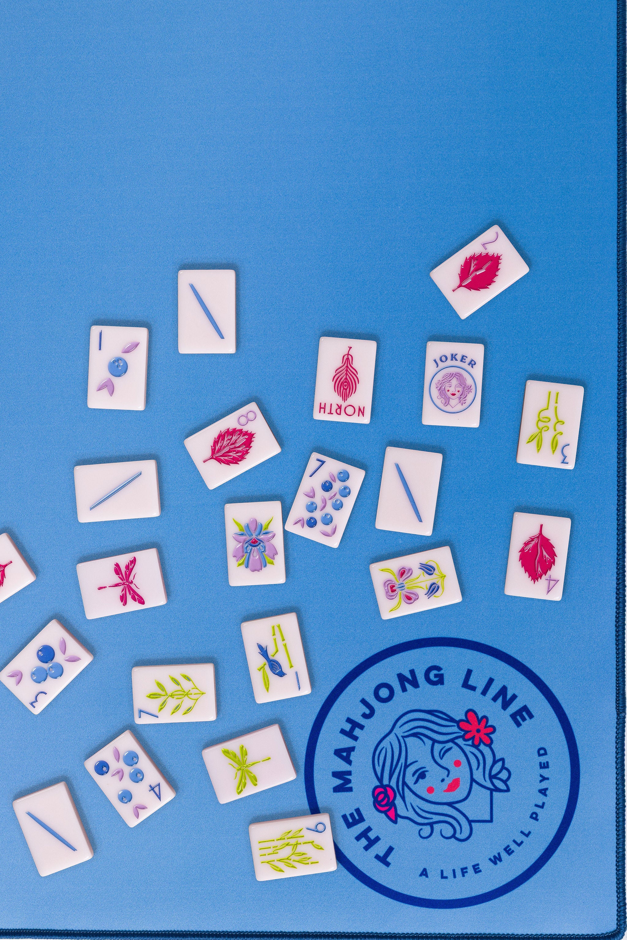 Light blue game mat paired with mahjong tiles– The Mahjong Line