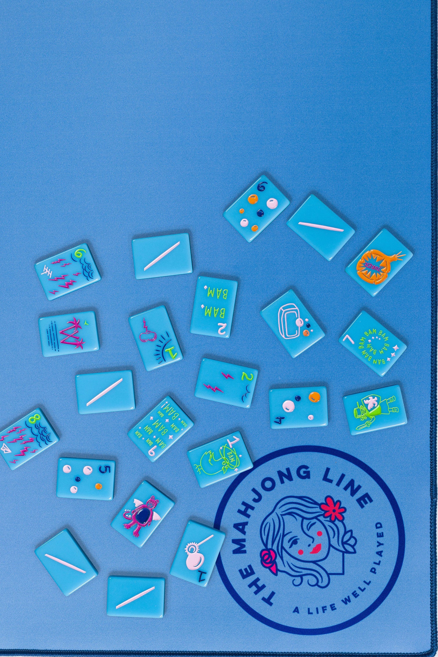 Light blue game mat paired with mahjong tiles– The Mahjong Line