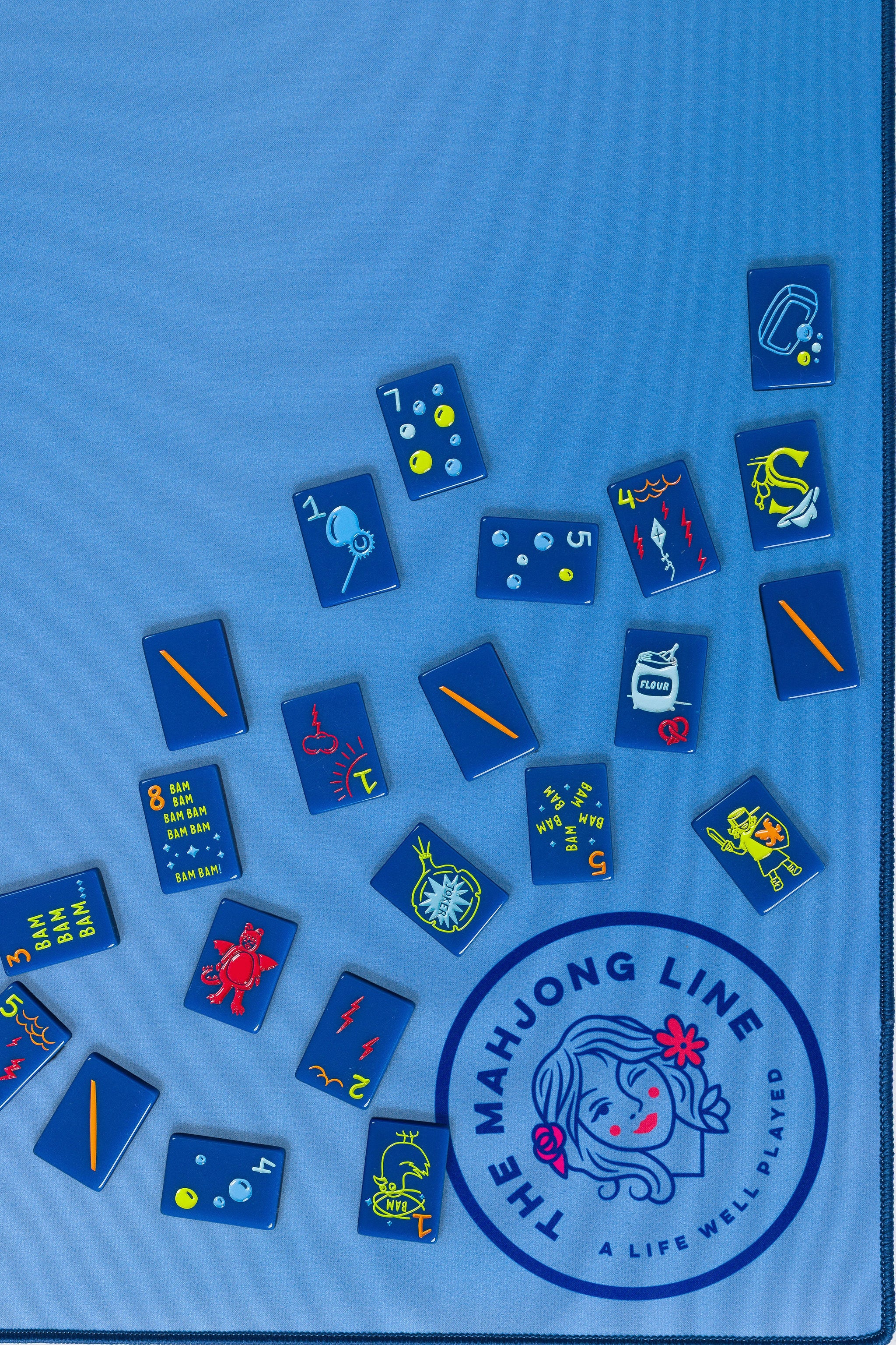 Light blue game mat paired with mahjong tiles– The Mahjong Line