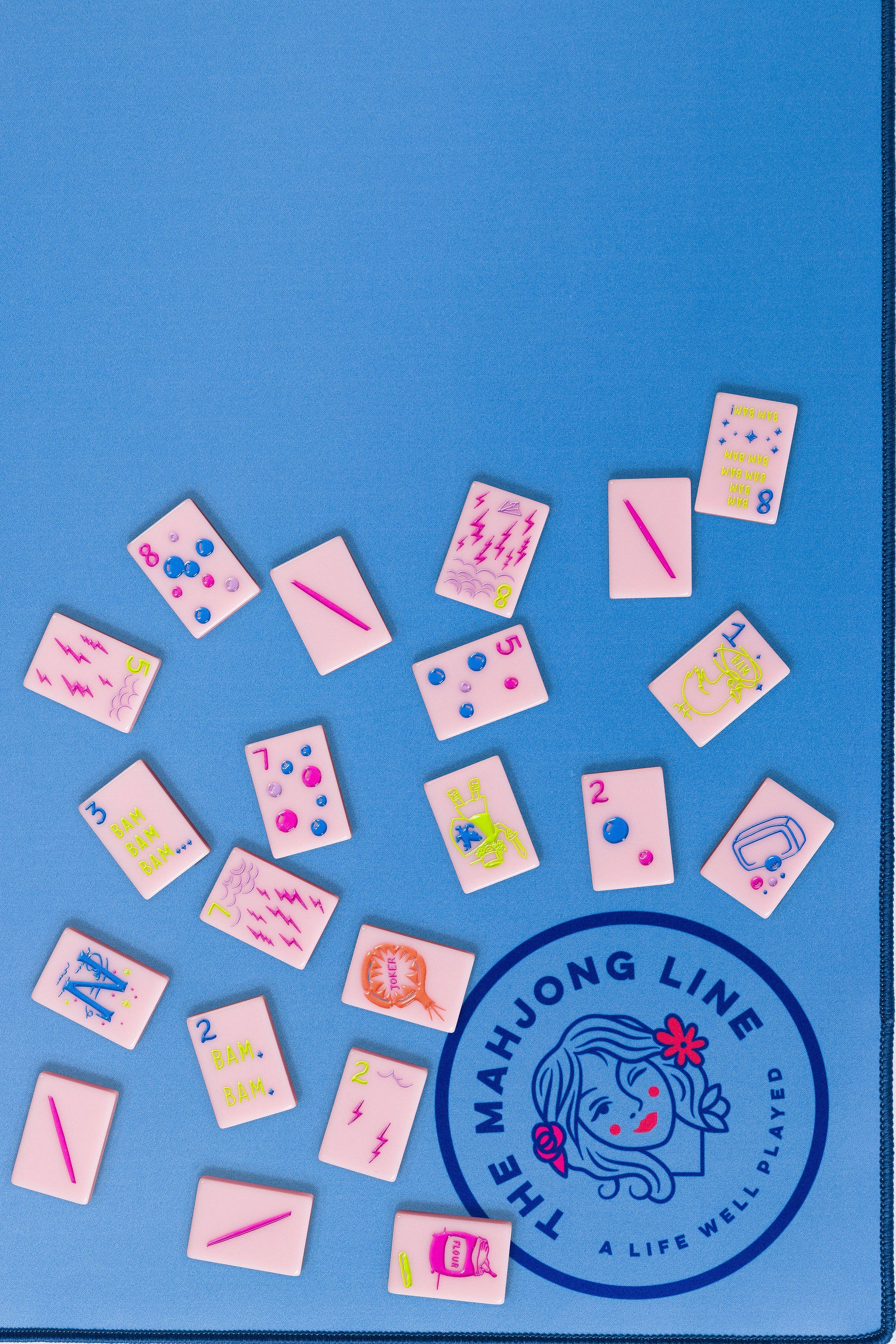 Light blue game mat paired with mahjong tiles– The Mahjong Line