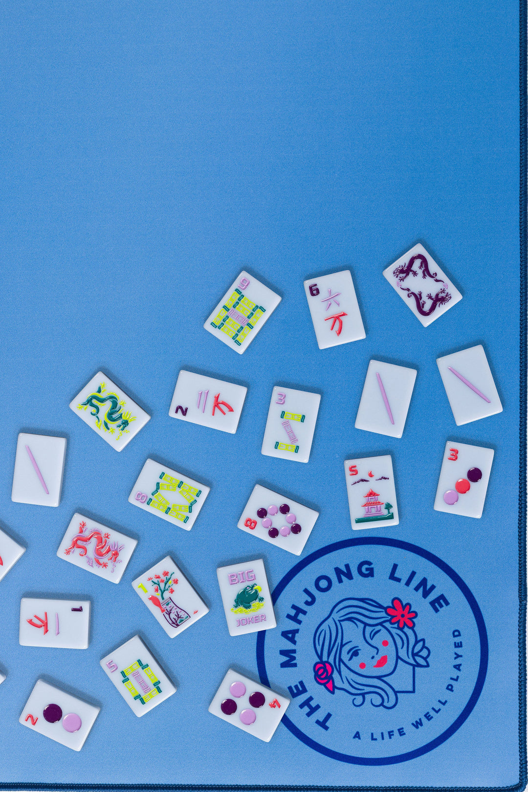 Light blue game mat paired with mahjong tiles– The Mahjong Line