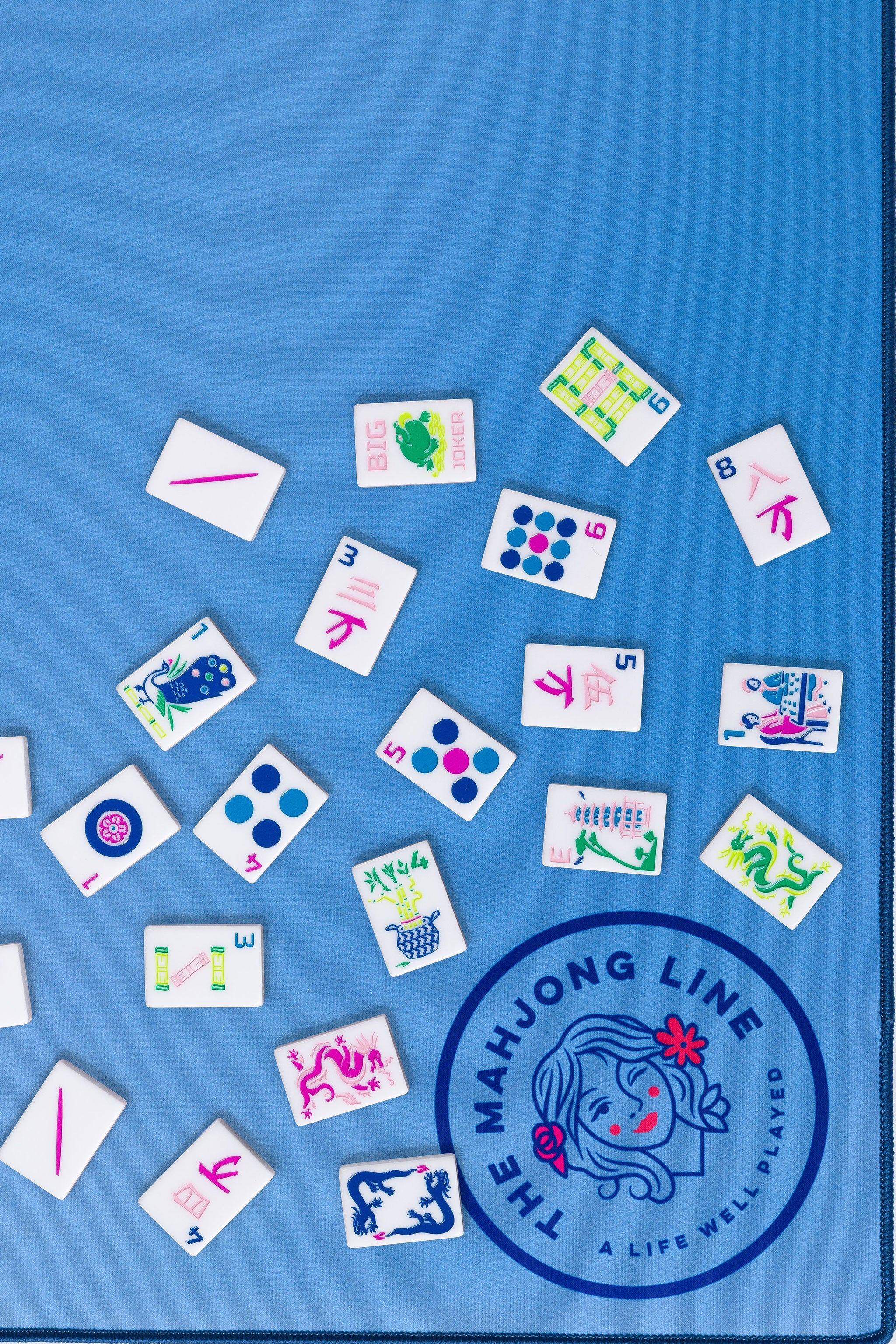 Light blue game mat paired with mahjong tiles– The Mahjong Line