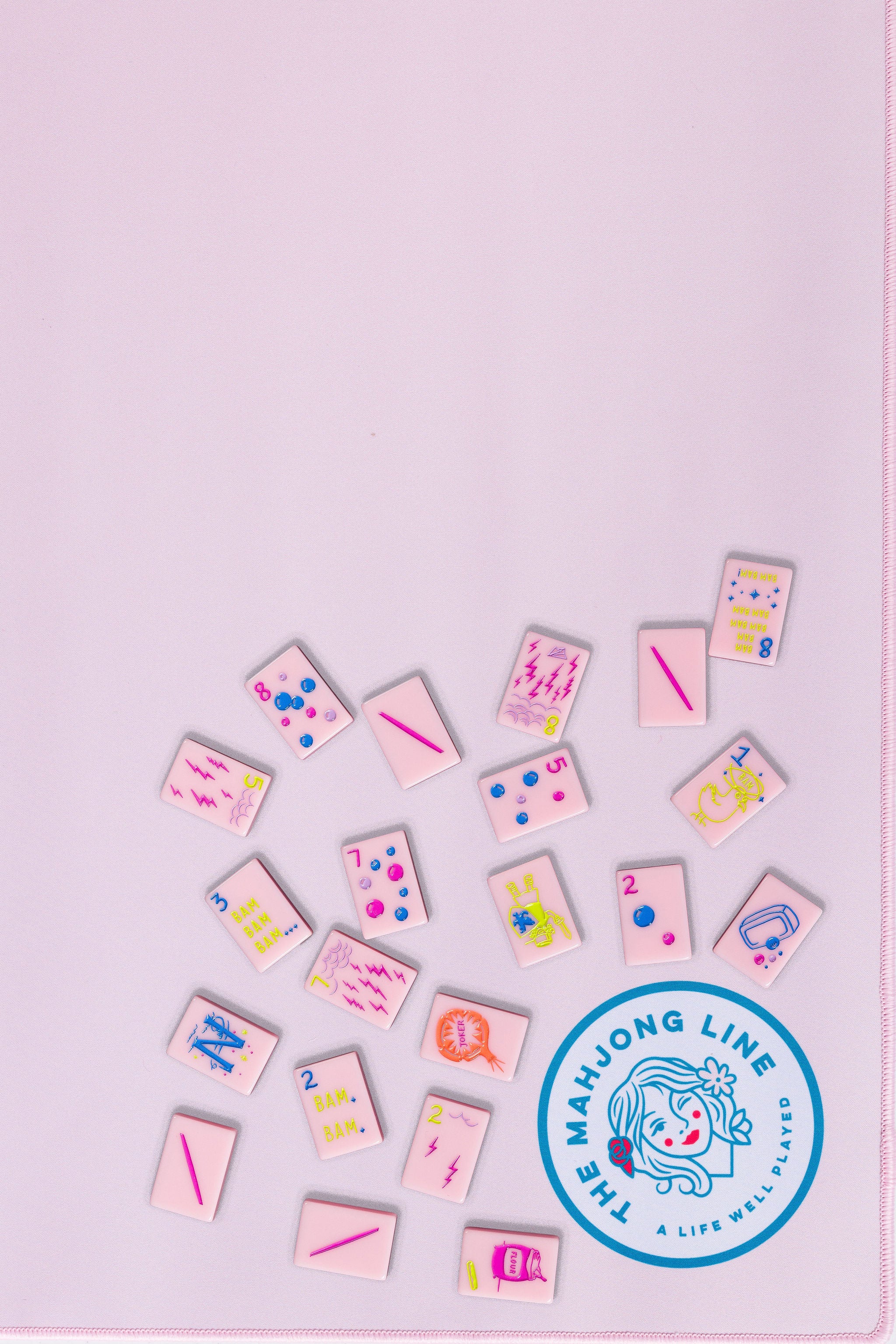 Pink game mat paired with mahjong tiles– The Mahjong Line