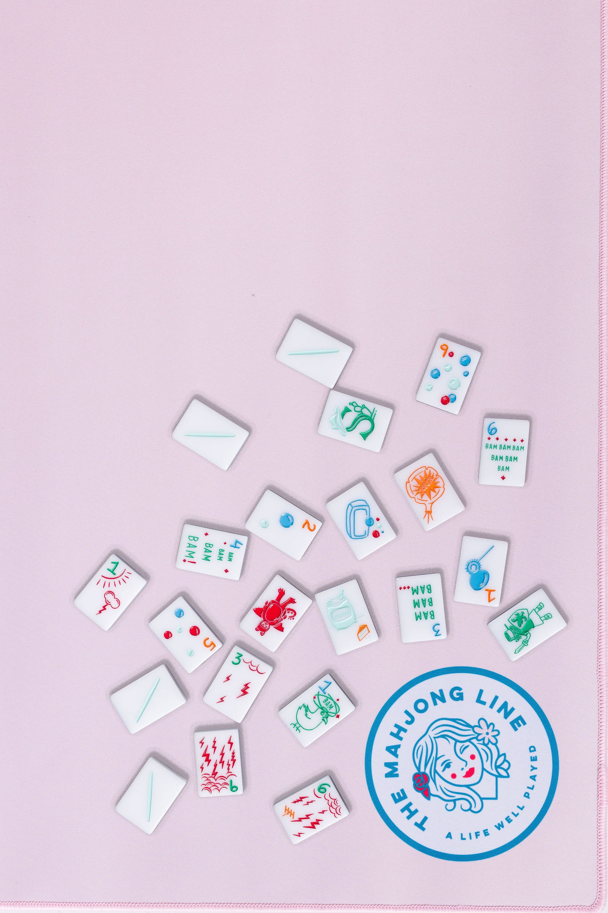 Pink game mat paired with mahjong tiles– The Mahjong Line