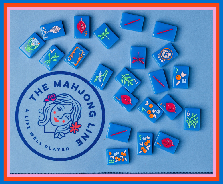 Light blue game mat paired with mahjong tiles– The Mahjong Line