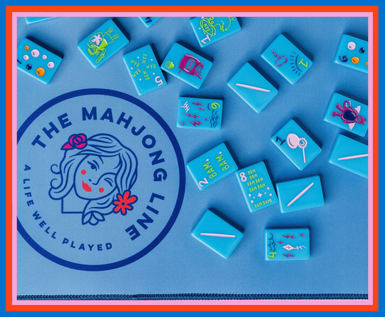 Light blue game mat paired with mahjong tiles– The Mahjong Line